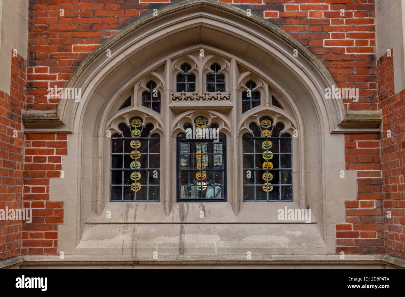 an historic decorative tracery stone and stained glass window in a ...