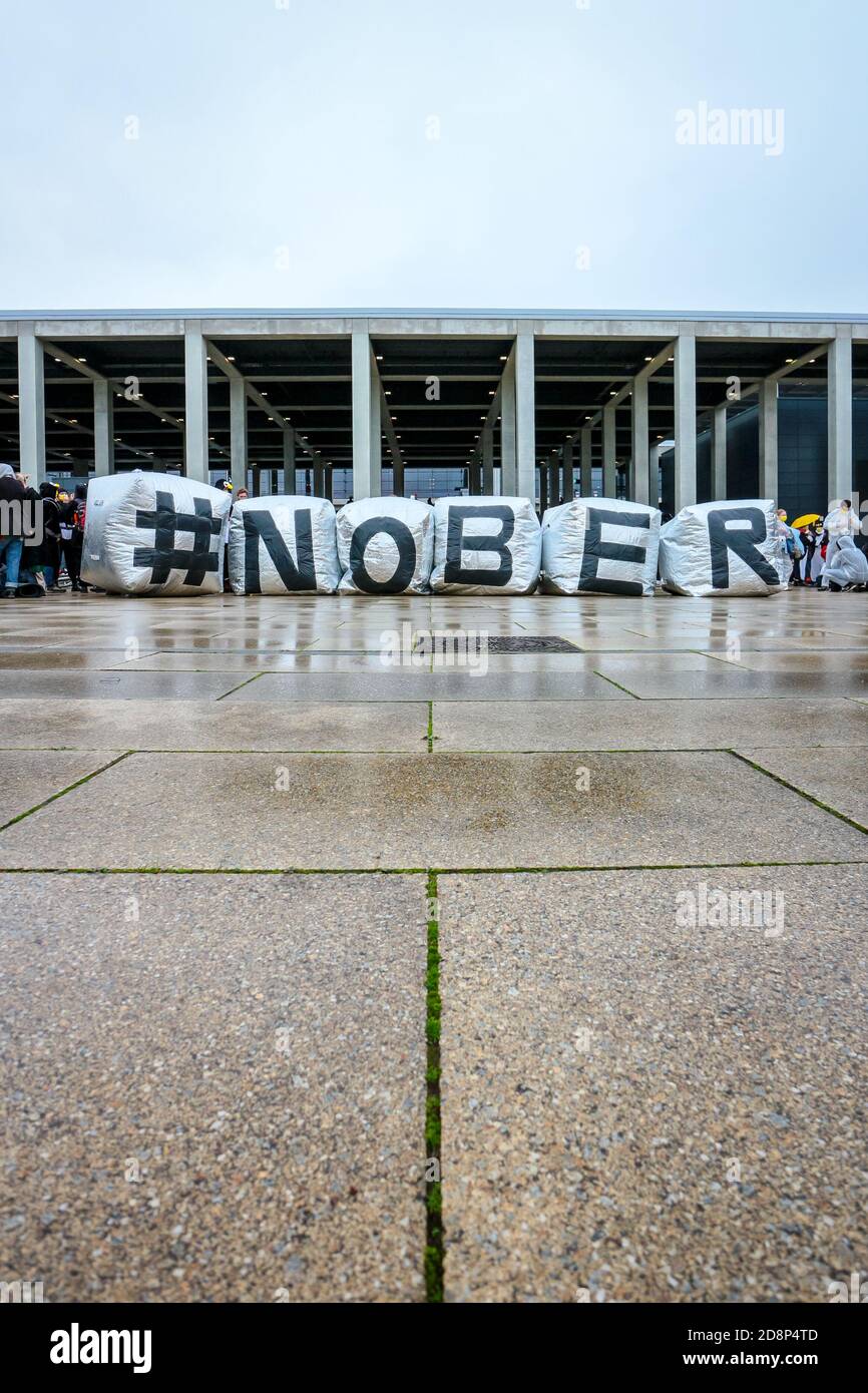 "#NOBER" is spelled out as climate activitists in penguin costumes ...