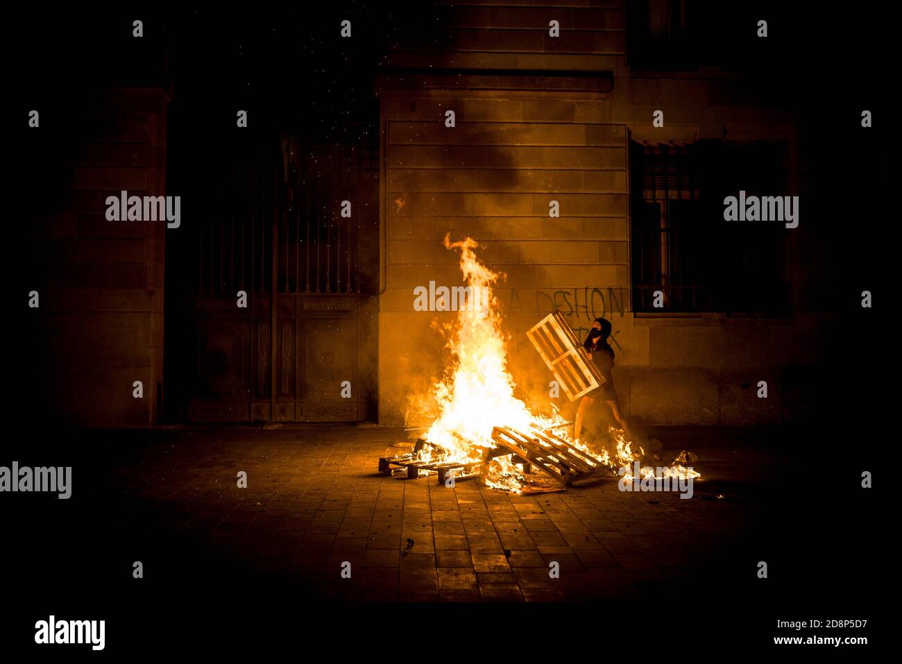 Barcelona, Spain. 31st Oct, 2020. Left-wing activists burn objects of a ...