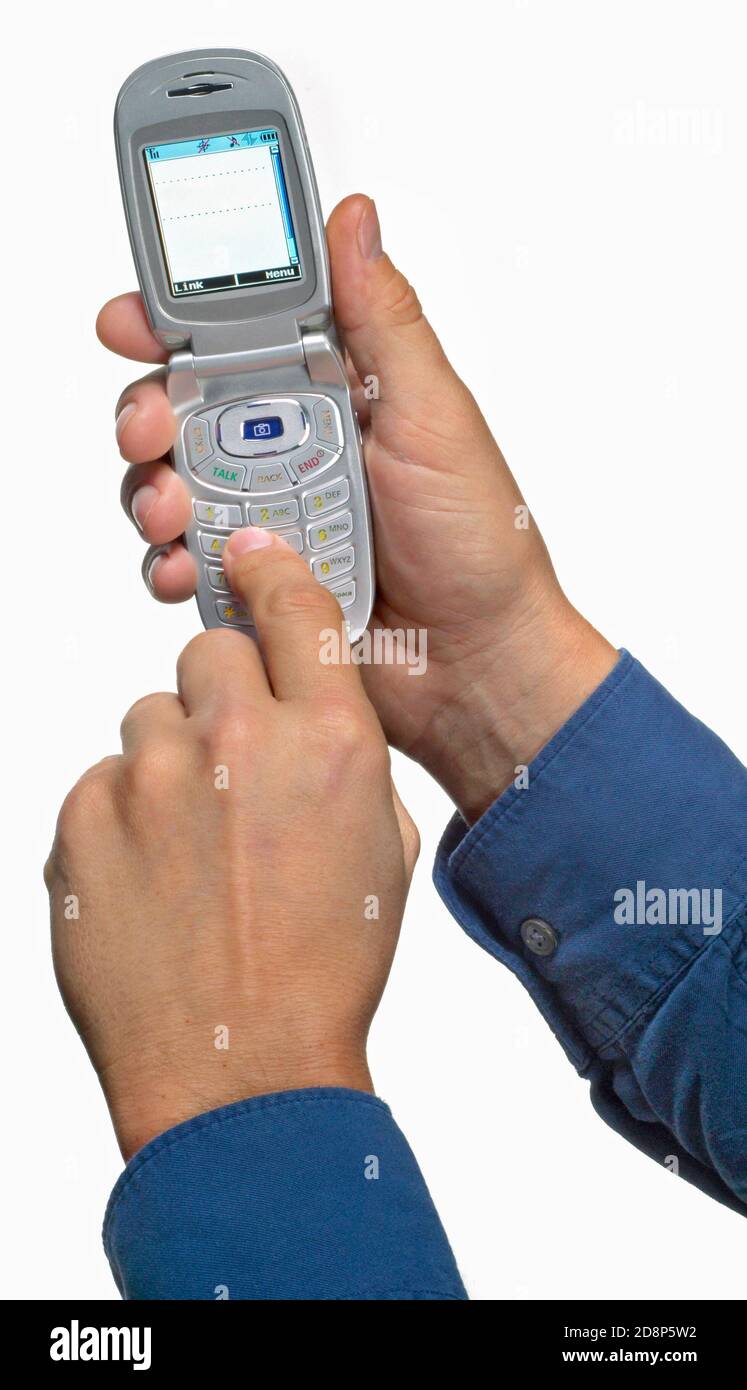 text messaging with a basic cell phone photographed on a white ...