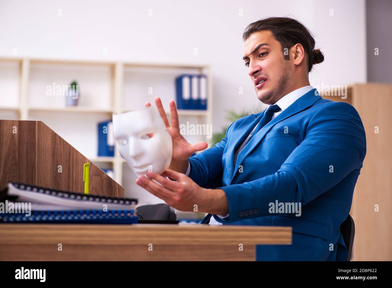 Young employee wearing mask in the office Stock Photo - Alamy