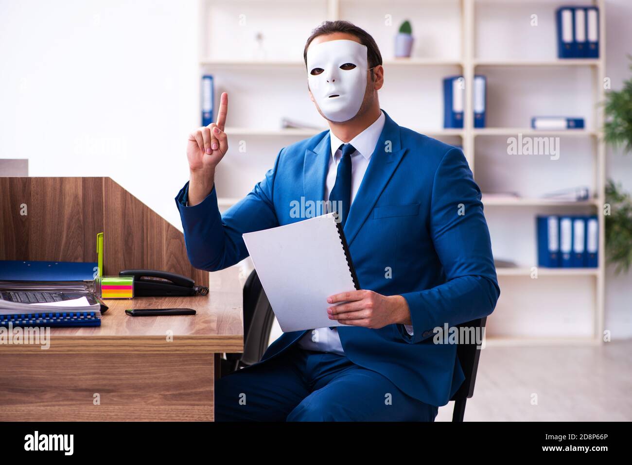 Young employee wearing mask in the office Stock Photo - Alamy
