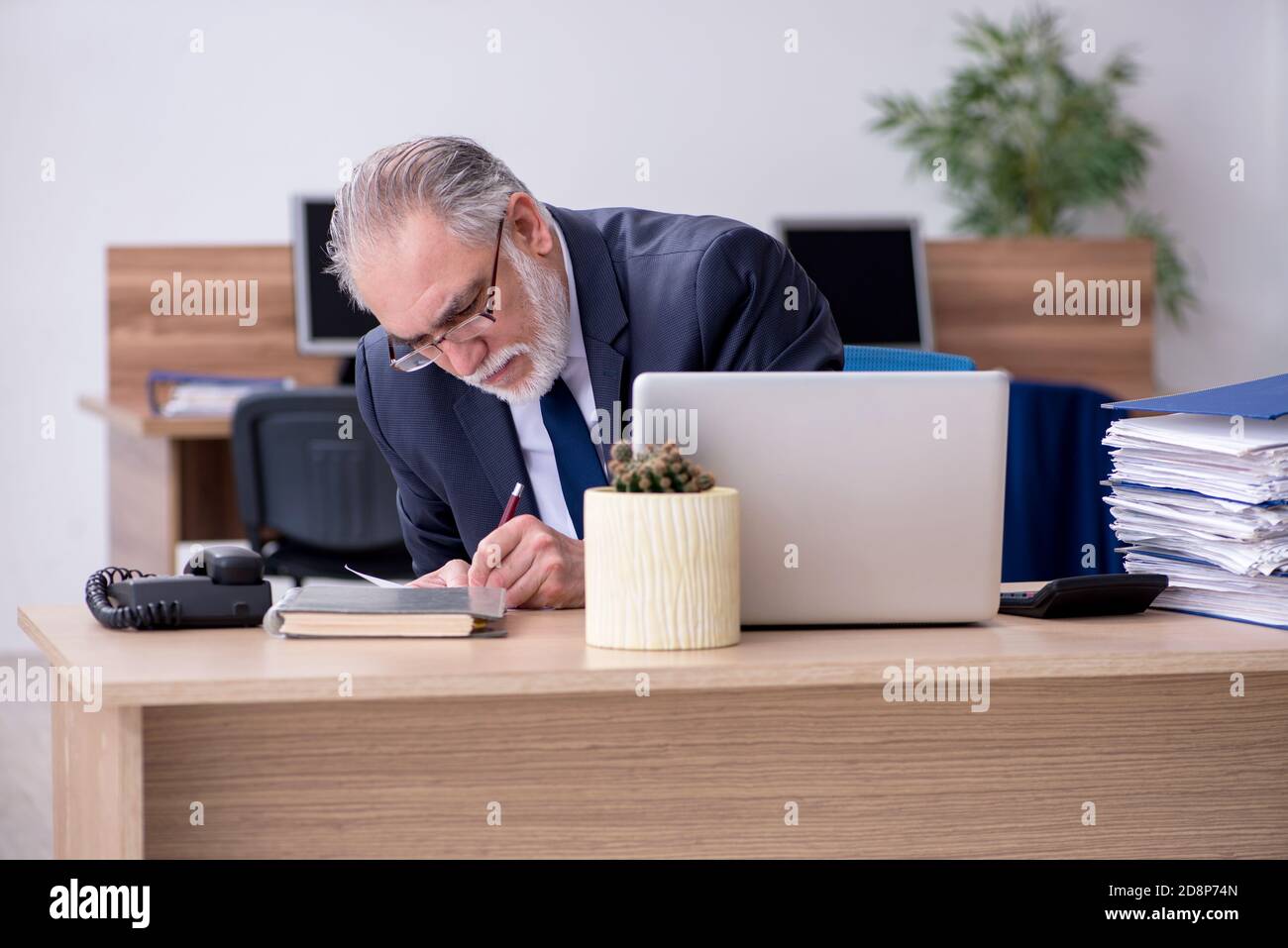 Old employee working in the office Stock Photo - Alamy
