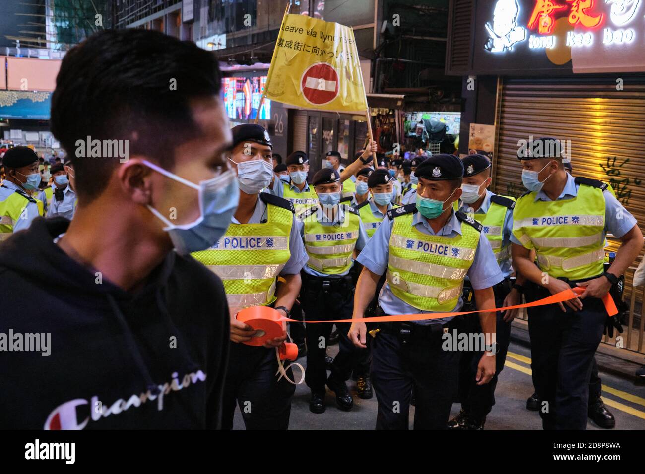 Police putting up a cordon line as a crowd control measure during ...