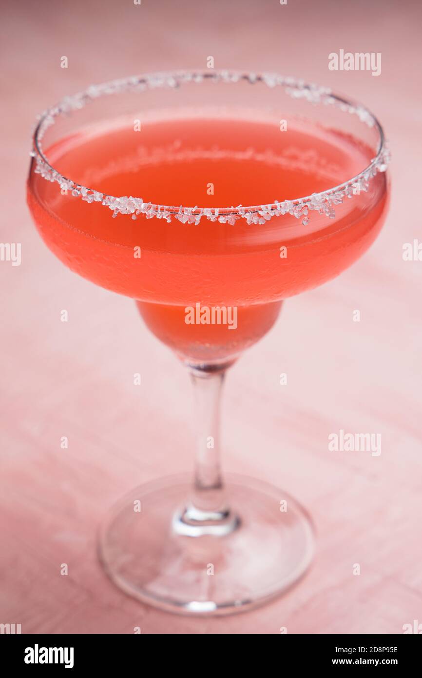 Red Margarita cocktail on a pink background Stock Photo - Alamy