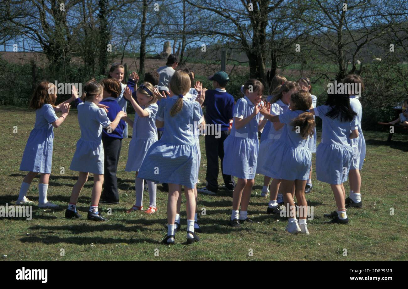 primary school children doing a traditional english country dance in ...
