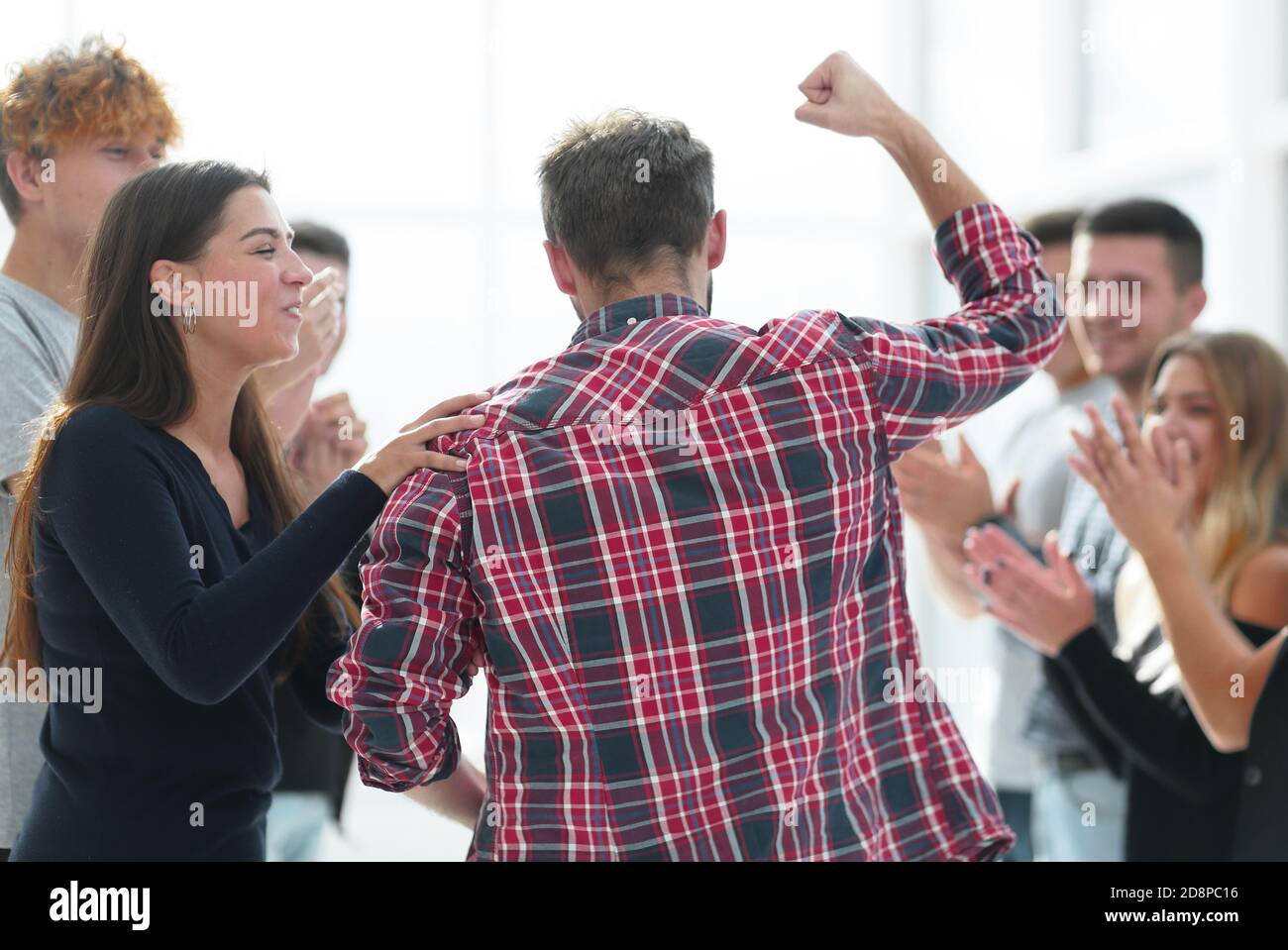 rear view . happy employee looking at the business team Stock Photo - Alamy
