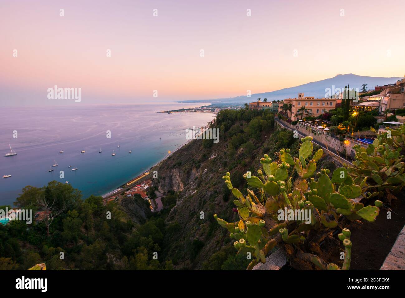 Landscape of Taormina surrounded by the sea during the sunset in Sicily ...