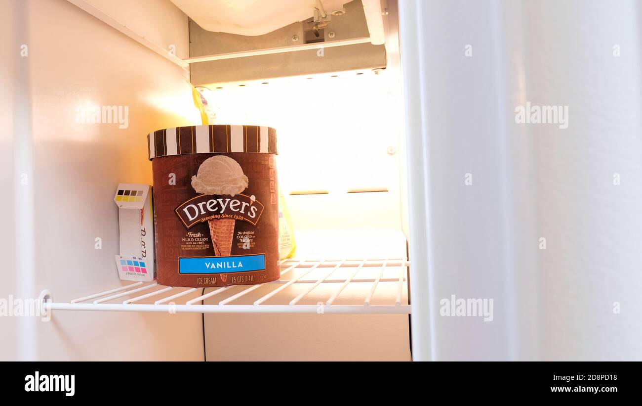 A one and a half quart container of Dreyer's vanilla ice cream inside ...
