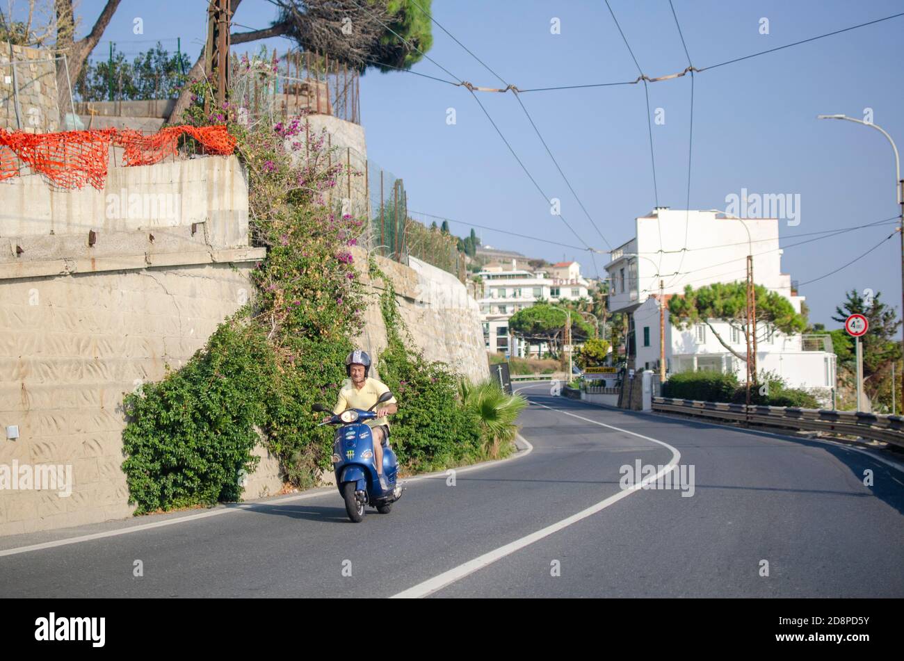 man on a scooter on an Italian coastal road Stock Photo - Alamy