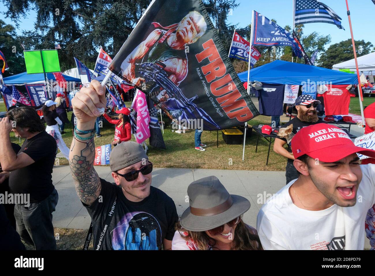 Los Angeles, California, USA. 31st Oct, 2020. People hold signs and ...