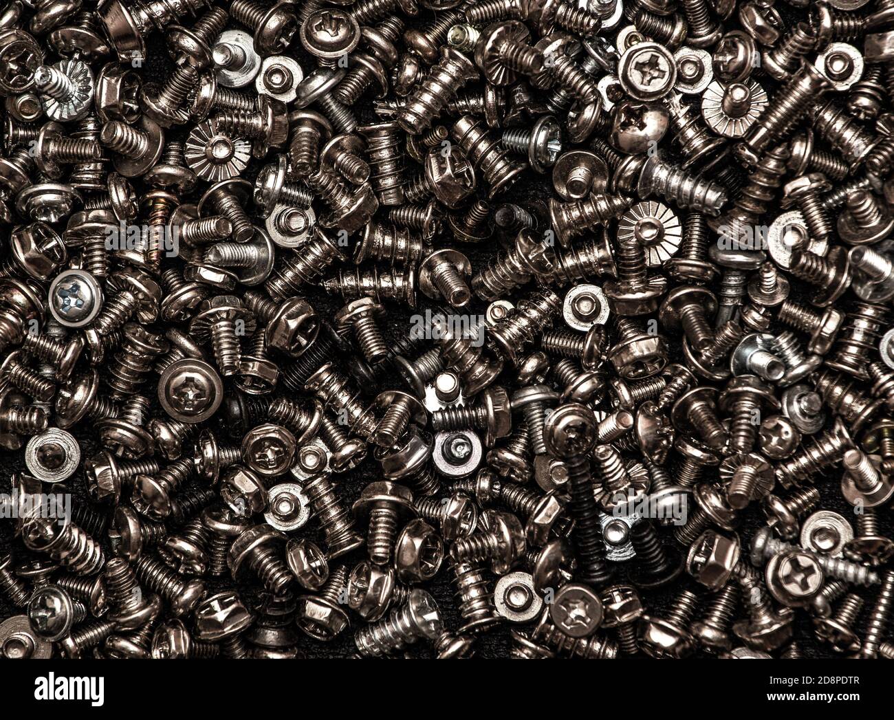 A background of silver screws and bolts. Various screws. Hardware Stock ...
