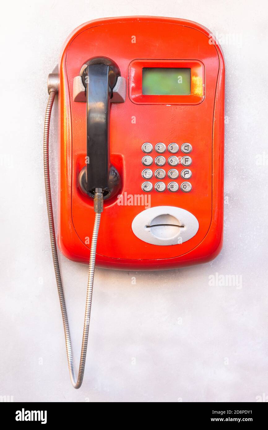 red landline phone with buttons on the wall Stock Photo - Alamy