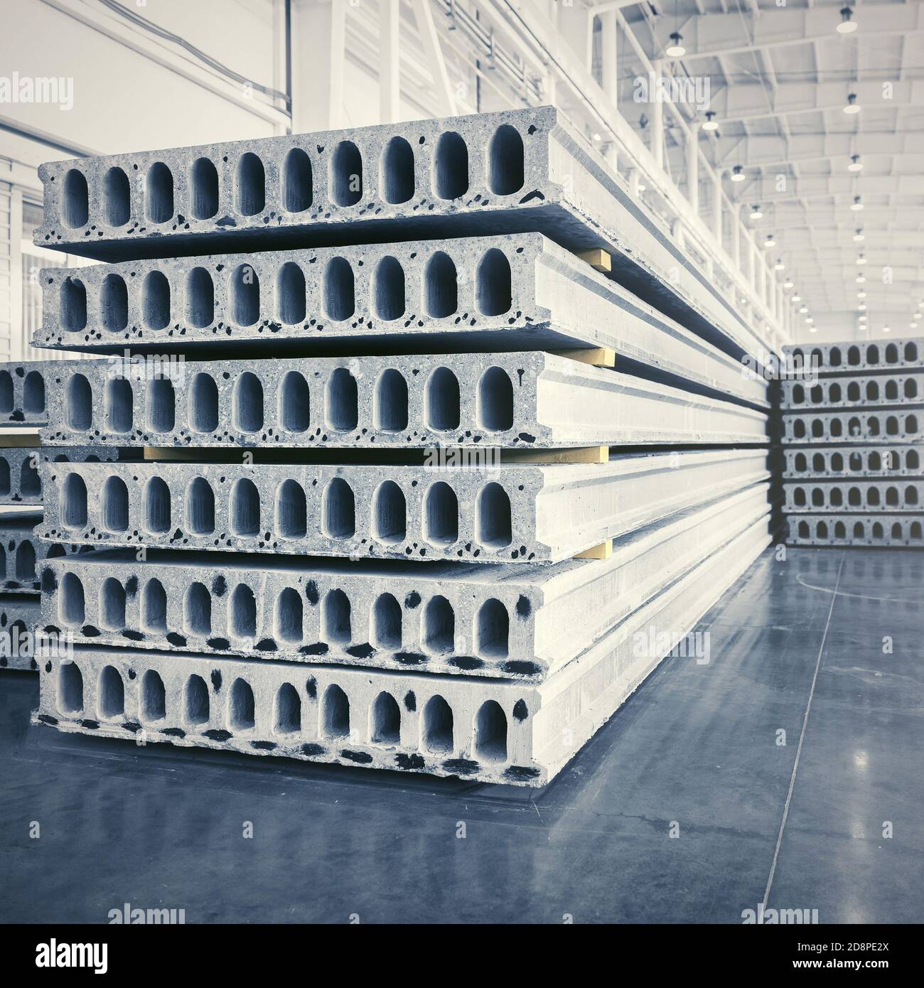 Stack of precast reinforced concrete slabs in a house-building factory ...
