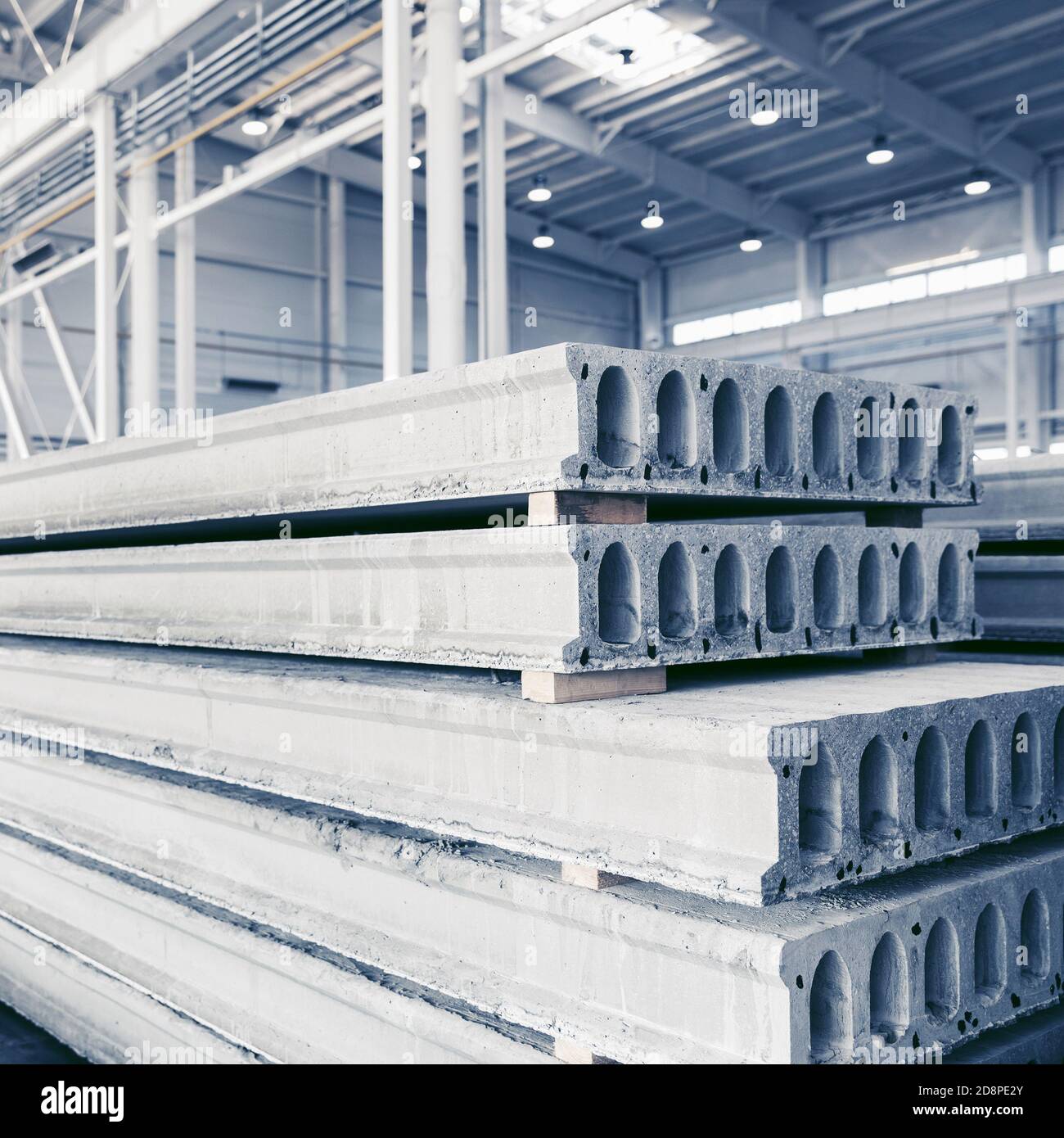 Stack of precast reinforced concrete slabs in a house-building factory ...