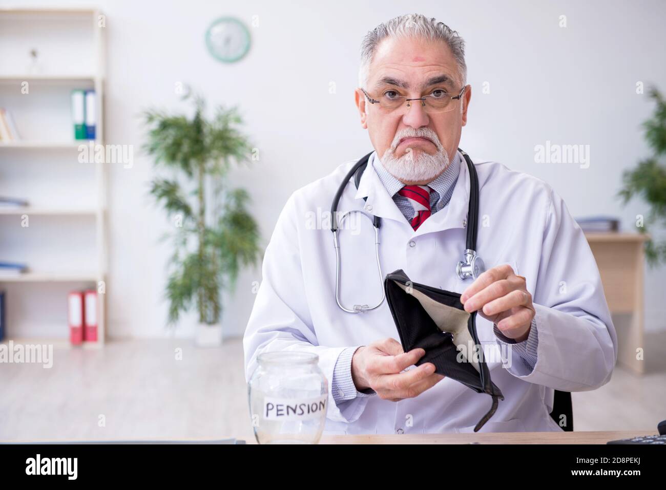 Old doctor in retirement concept Stock Photo - Alamy