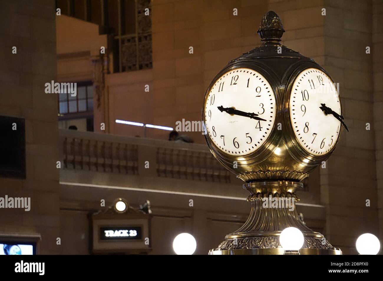 Grand Central Terminal with a big clock above information and pillars ...