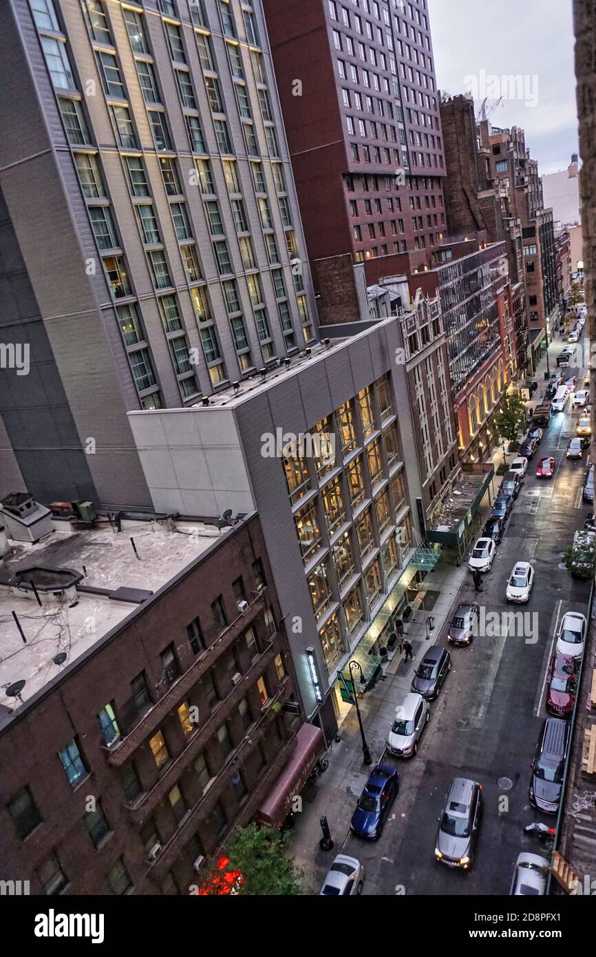 A view from a window looking down on a busy street and buildings in ...