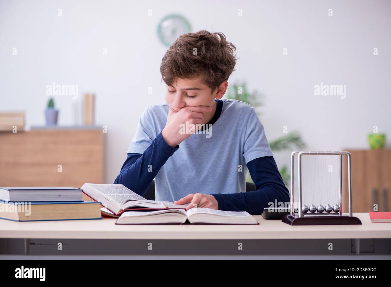 Boy studying physics at home Stock Photo - Alamy