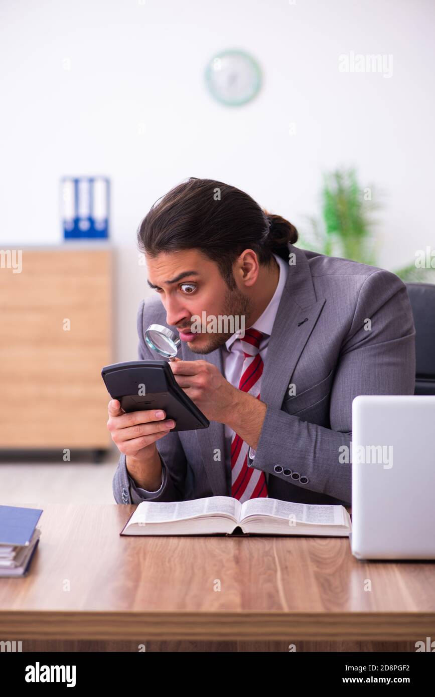 Male bookkeeper working in the office Stock Photo - Alamy