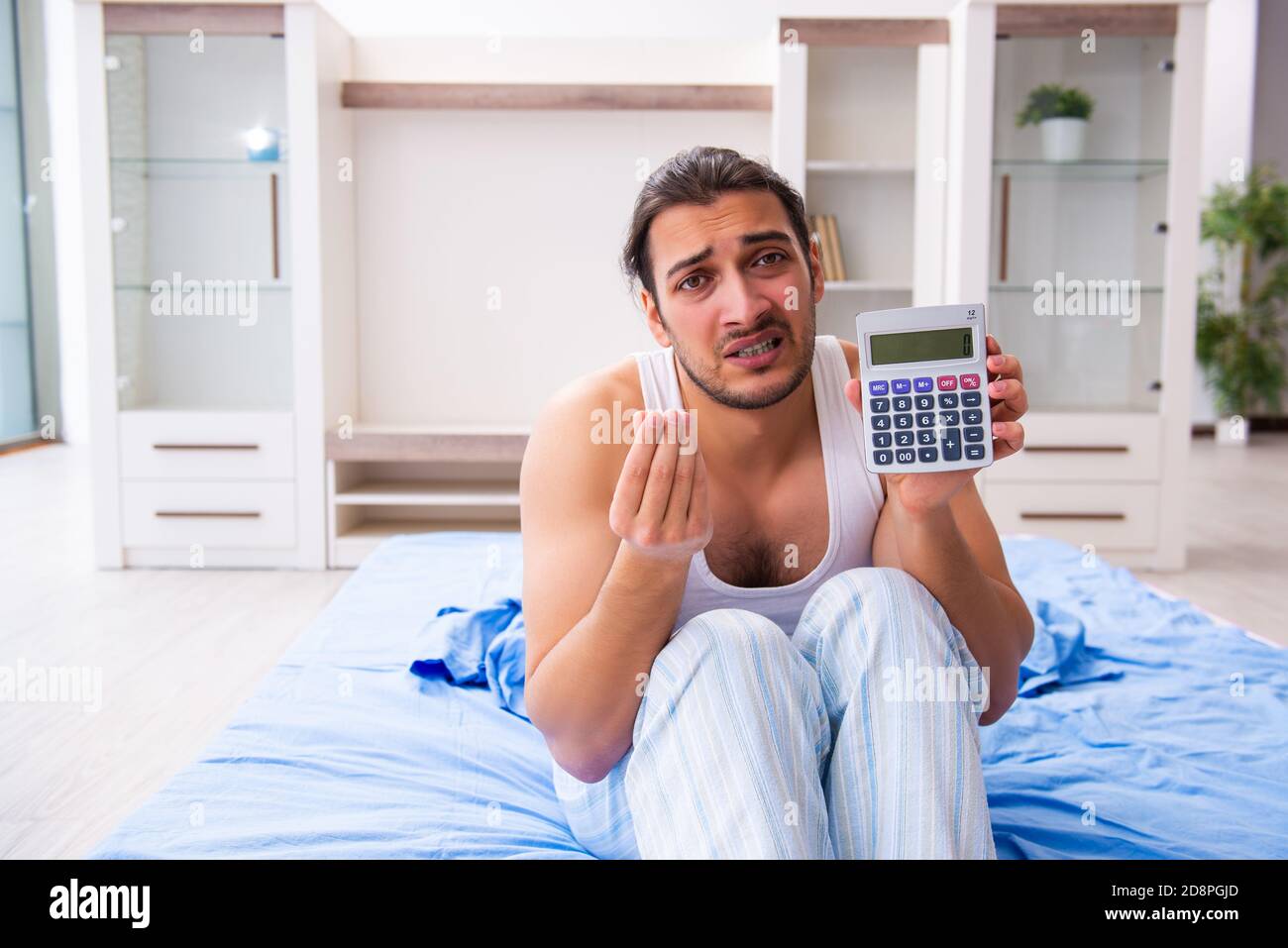 Young man in insolvency concept Stock Photo - Alamy