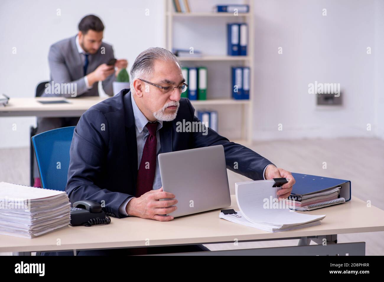 Old boss and his assistant working in the office Stock Photo - Alamy