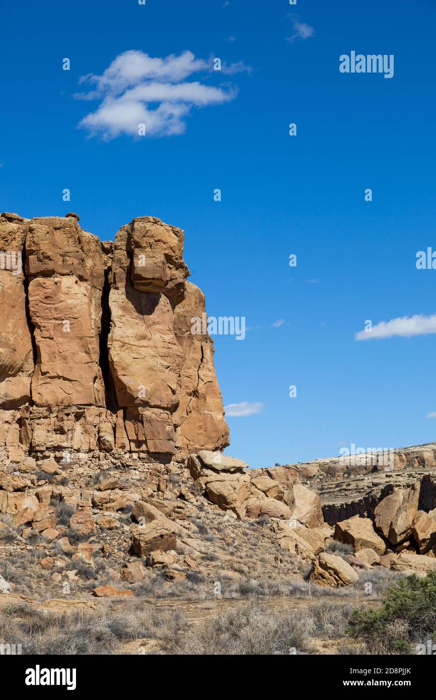 Ancient cracked sandstone cliffs with large boulders in the debris ...