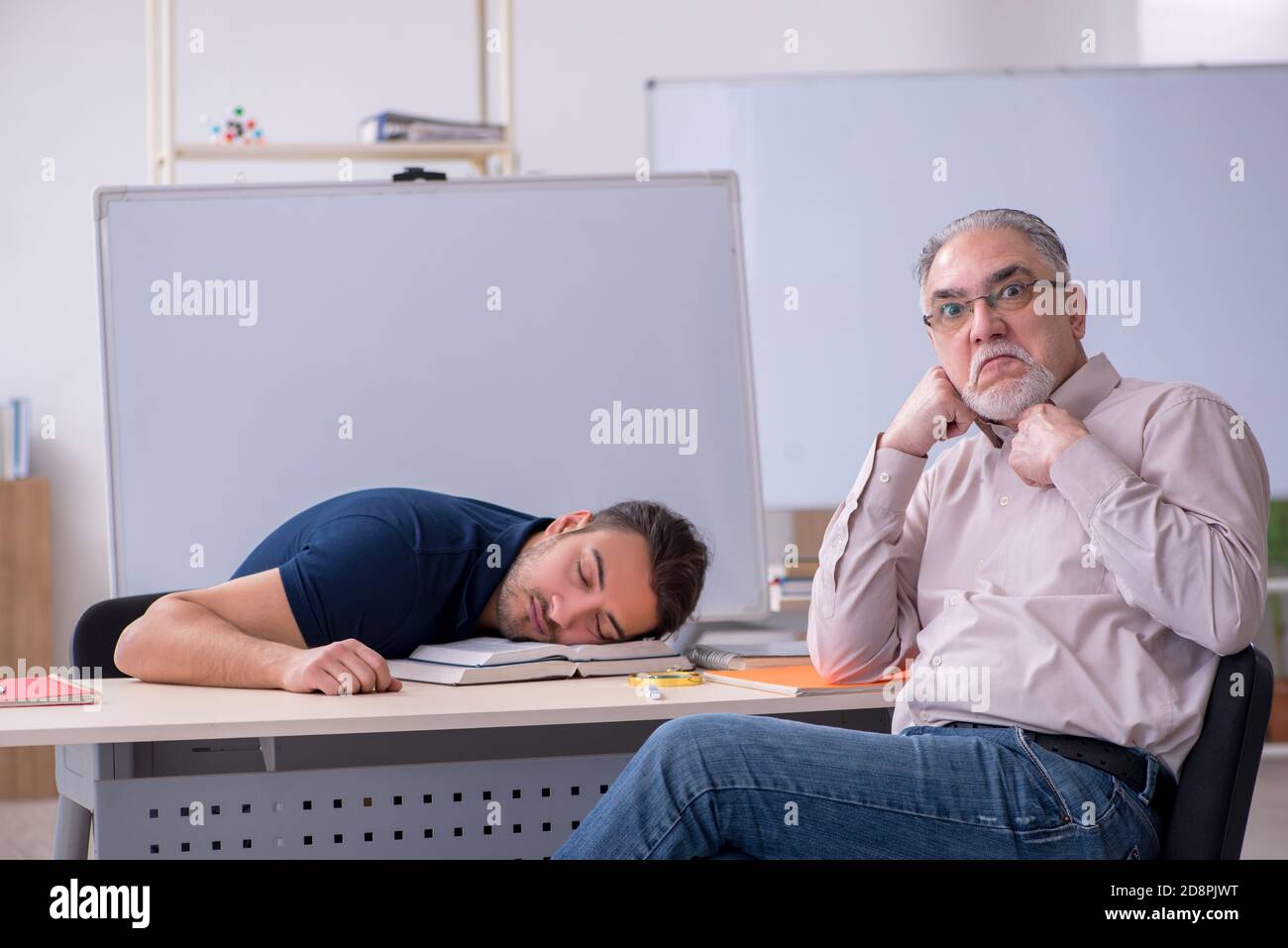 Old teacher and young student in the classroom Stock Photo - Alamy