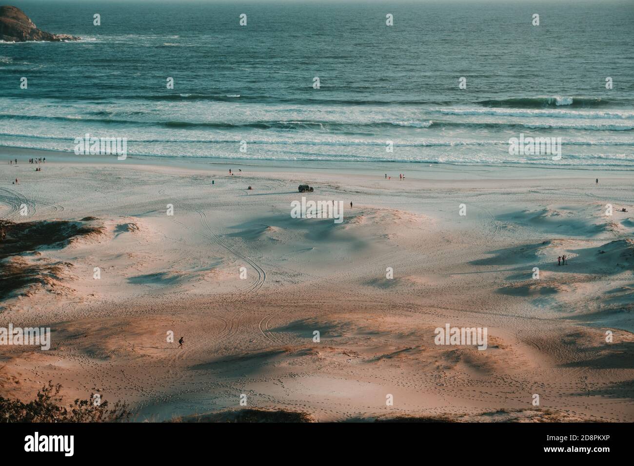 Aerial view of the wavy ocean hitting the sandy beach in Rio de Janeiro ...