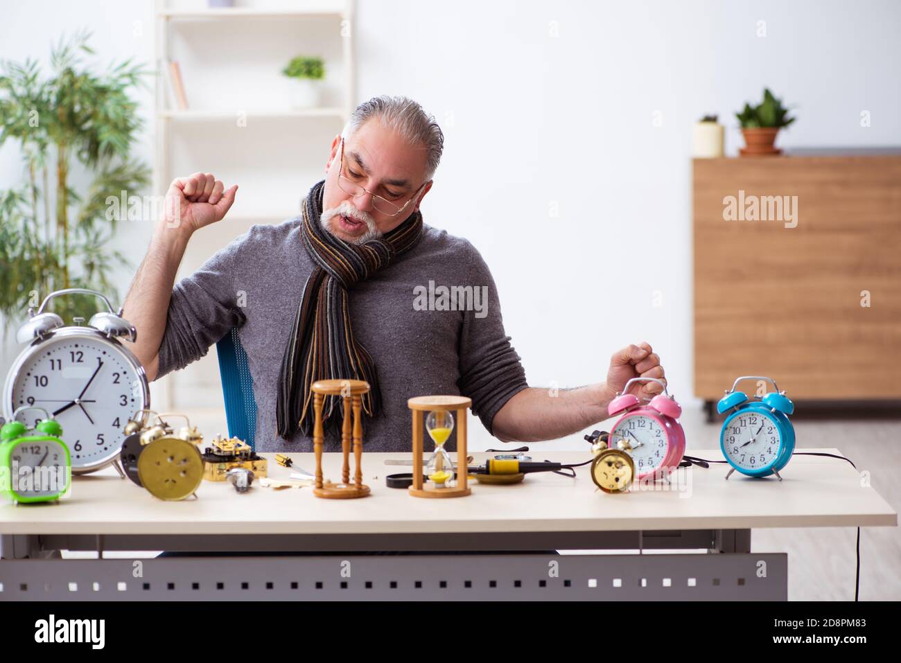 Old watchmaker working in the workshop Stock Photo - Alamy