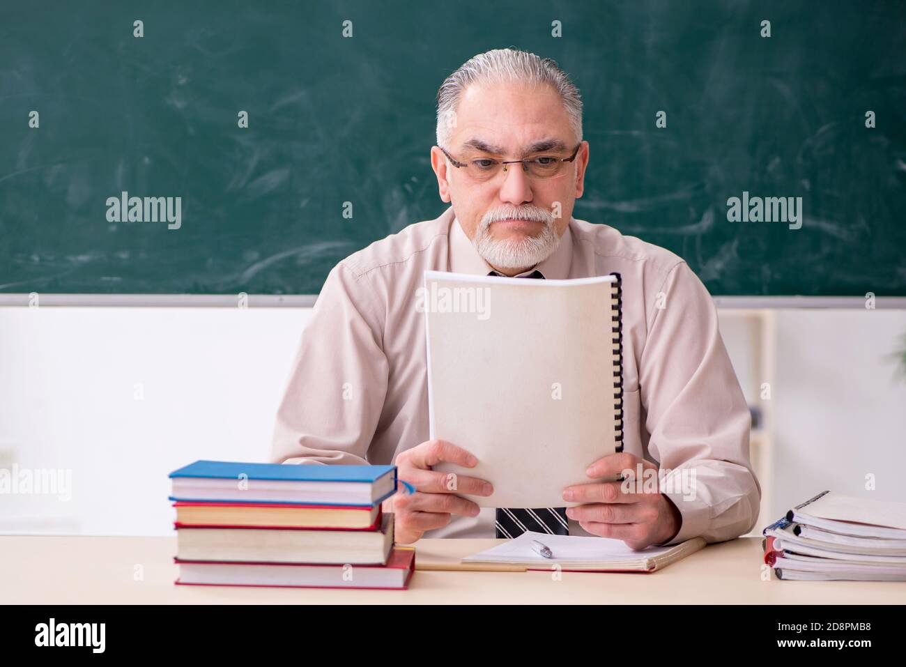 Old experienced teacher in the classroom Stock Photo - Alamy
