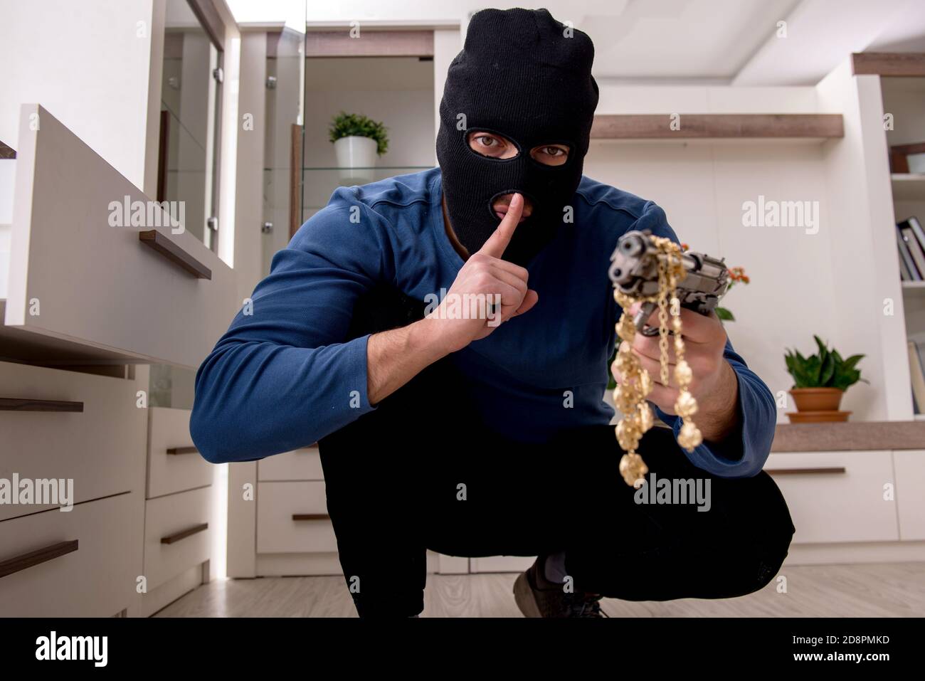 Robber stealing valuable things from the house Stock Photo - Alamy