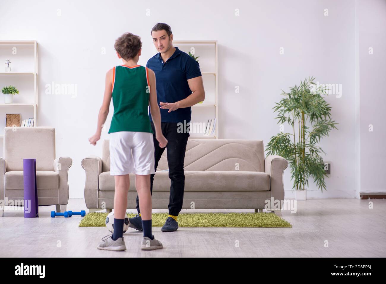 Father and son doing sport exercises at home Stock Photo - Alamy