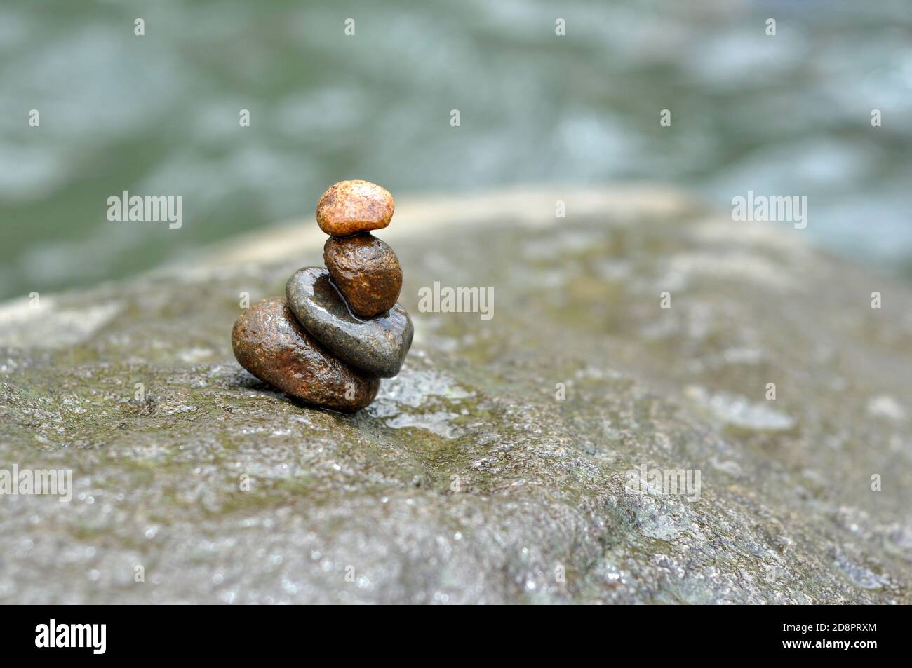 Rock stacking or rock balancing in river Stock Photo - Alamy