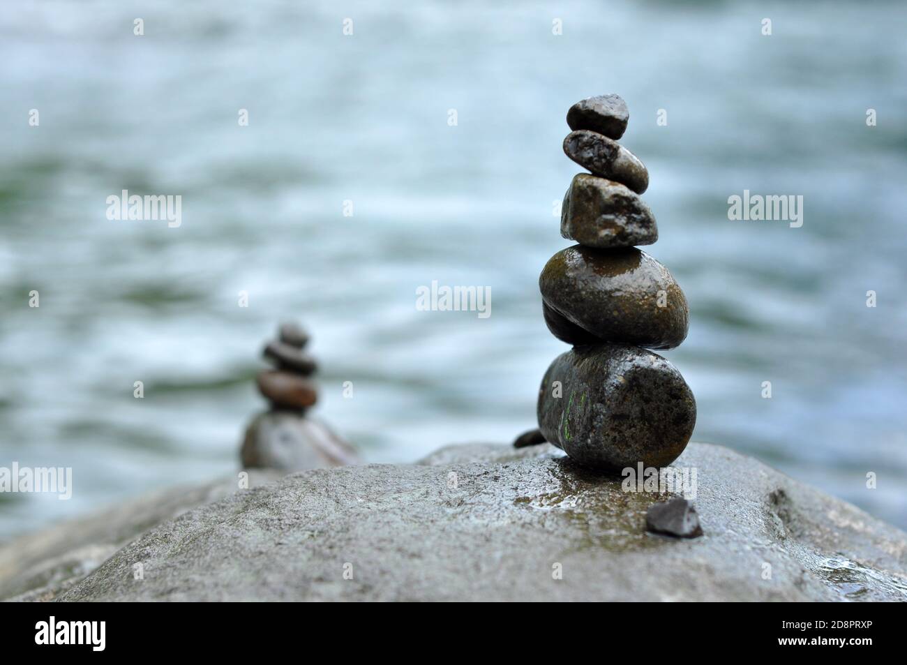 Rock stacking or rock balancing in river Stock Photo - Alamy