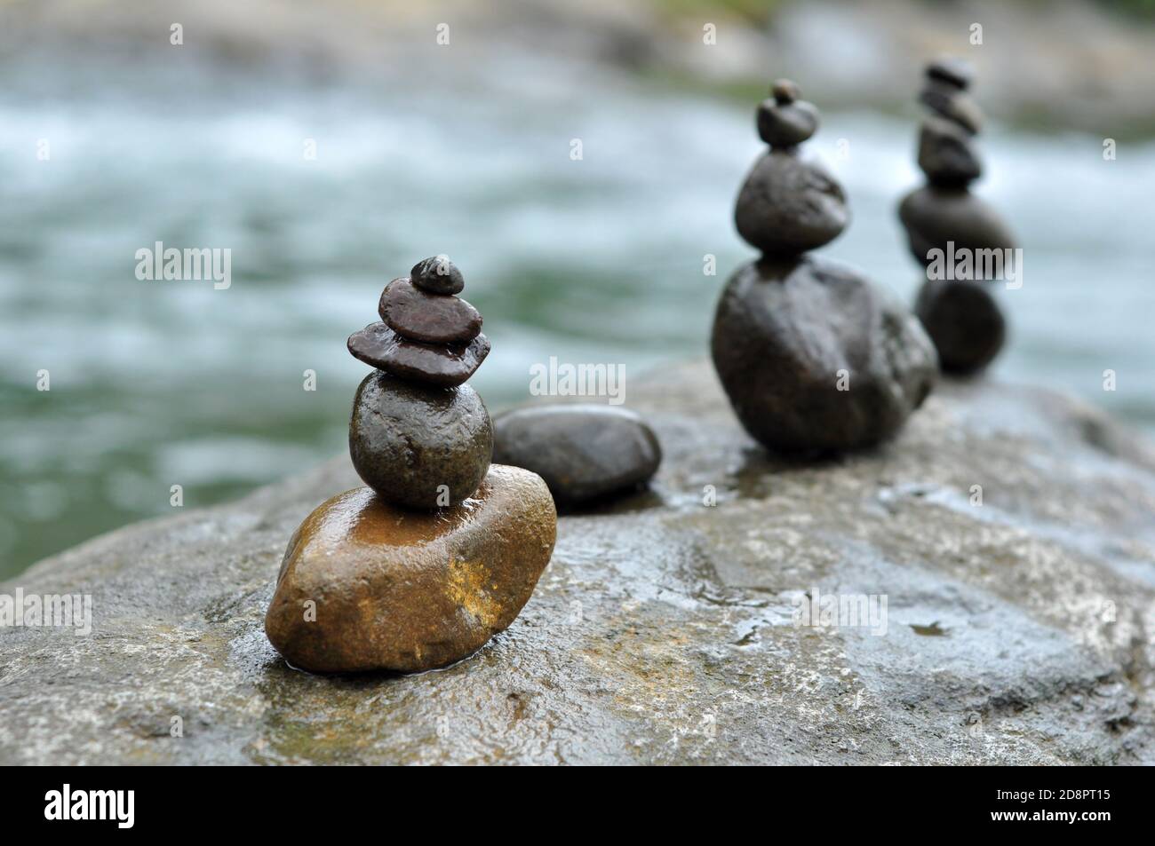 Rock stacking or rock balancing in river Stock Photo - Alamy