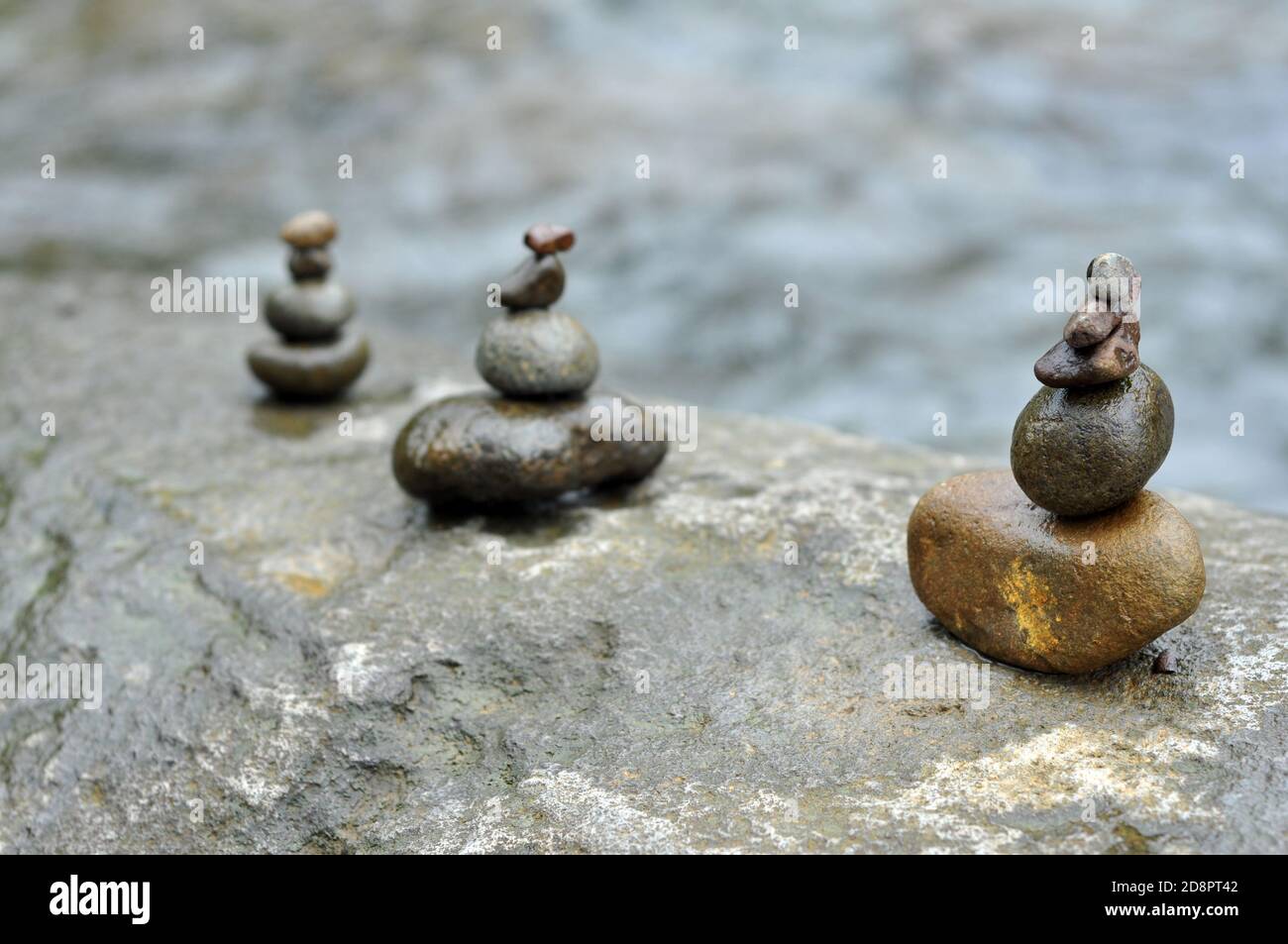 Rock stacking or rock balancing in river Stock Photo - Alamy