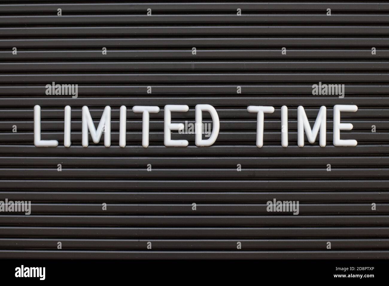 Black color felt letter board with white alphabet in word limited time ...