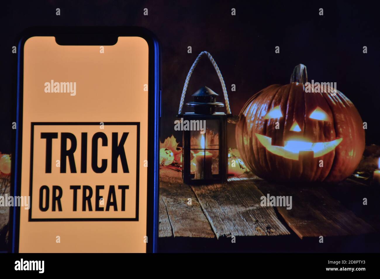 Trick or Treat text on mobile phone with Halloween background Stock ...