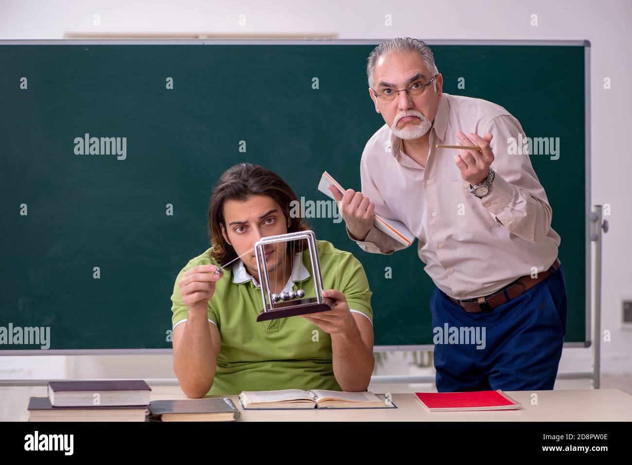 Old professor physicist and student in the classroom Stock Photo - Alamy