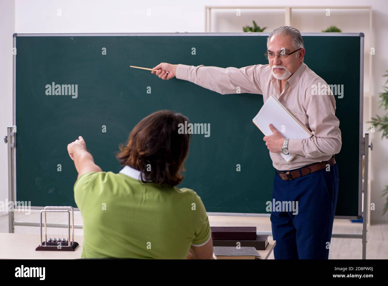 Old professor physicist and student in the classroom Stock Photo - Alamy