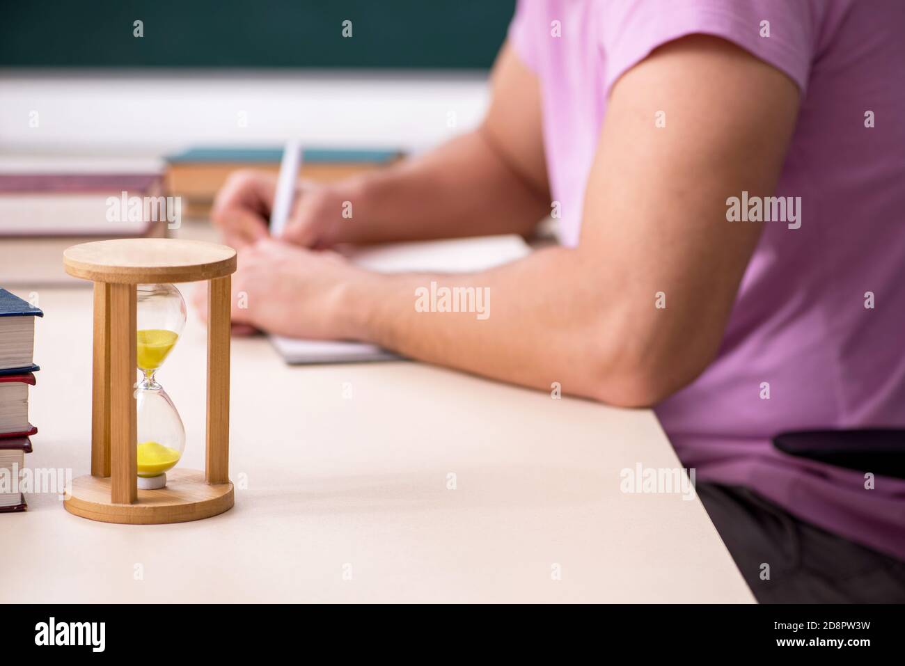 Young student in the classroom at time management concept Stock Photo ...
