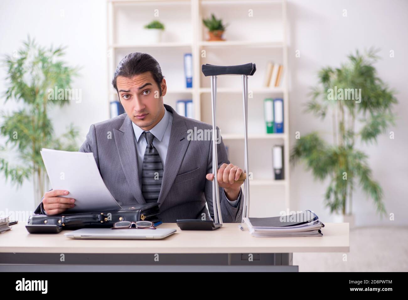 Young employee after accident at workplace Stock Photo - Alamy