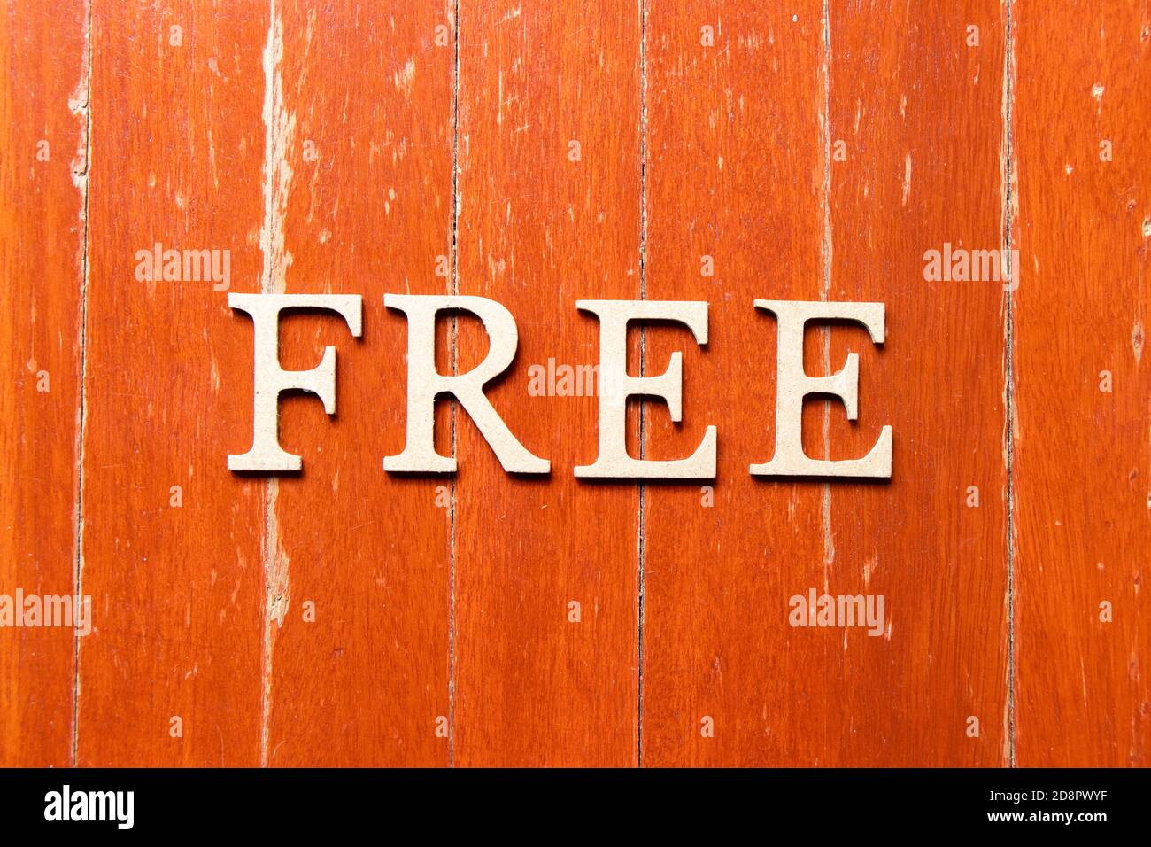 Alphabet letter in word free on old red color wood plate background ...