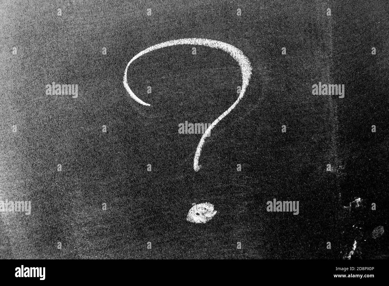 White color chalk hand drawing in question mark shape on blackboard ...