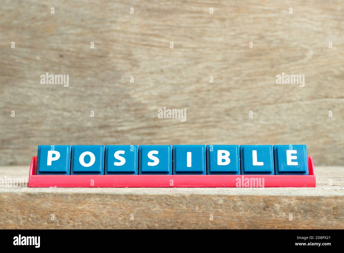Tile letter on red rack in word possible on wood background Stock Photo ...