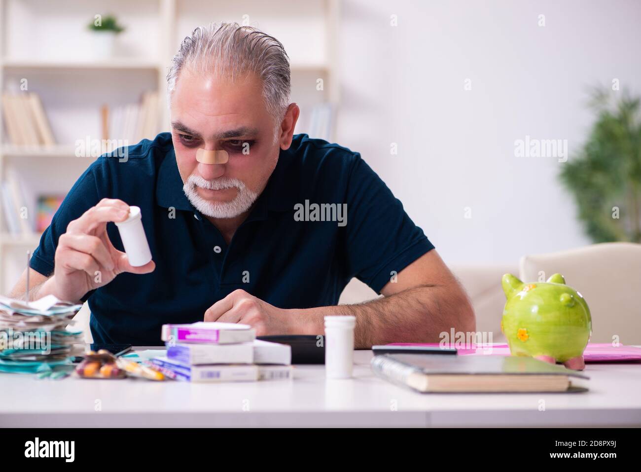 Old man in budget planning concept Stock Photo - Alamy