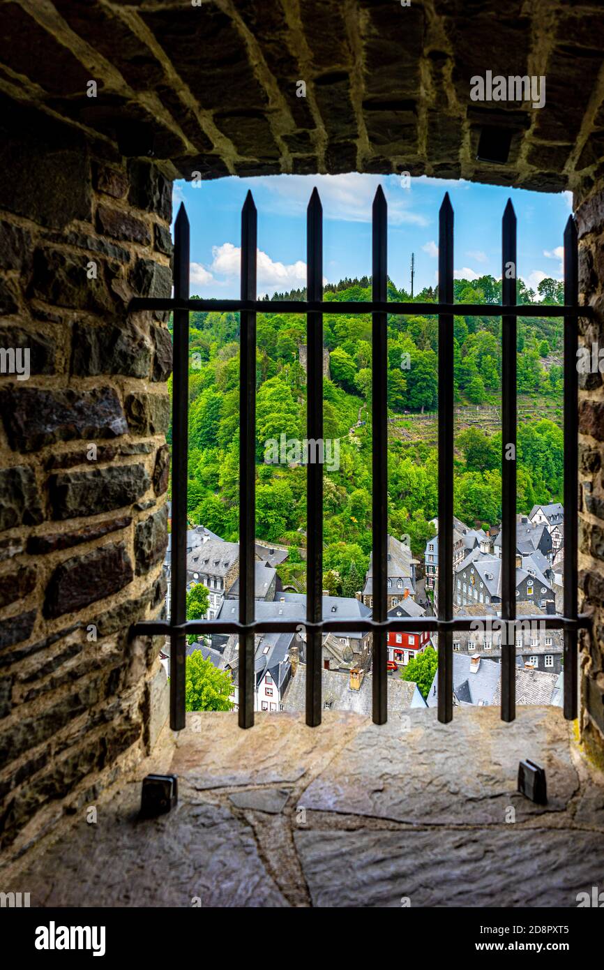 Vertical shot of bars in a window of the castle overlooking the city ...