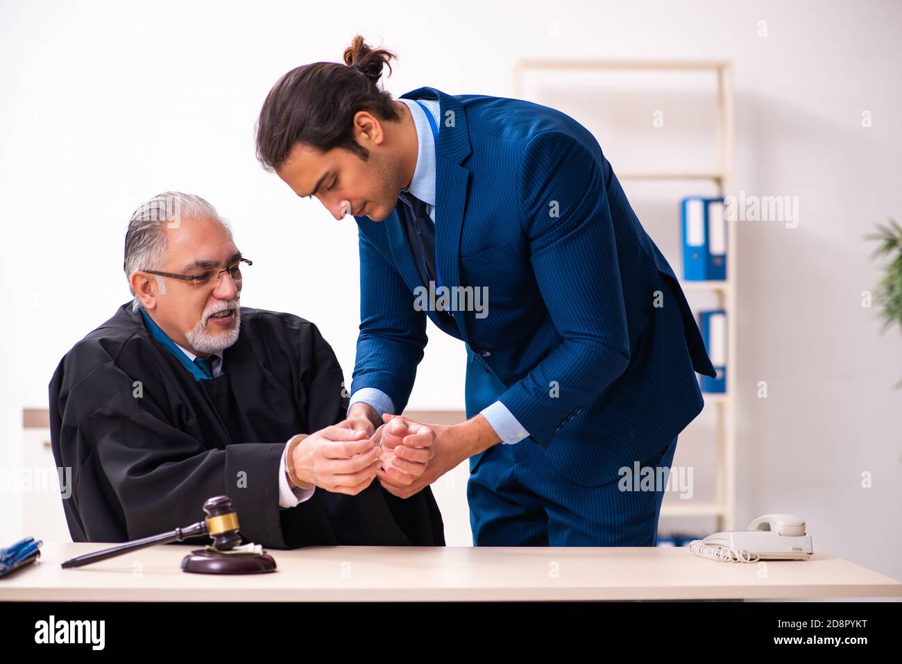 Police inspector arresting judge in court Stock Photo - Alamy