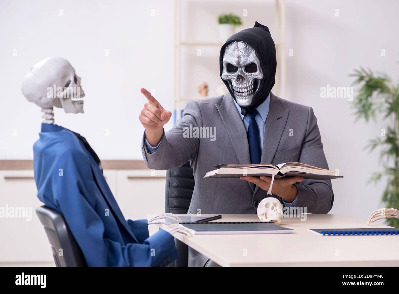 Funny business meeting with the devil and skeletons Stock Photo - Alamy